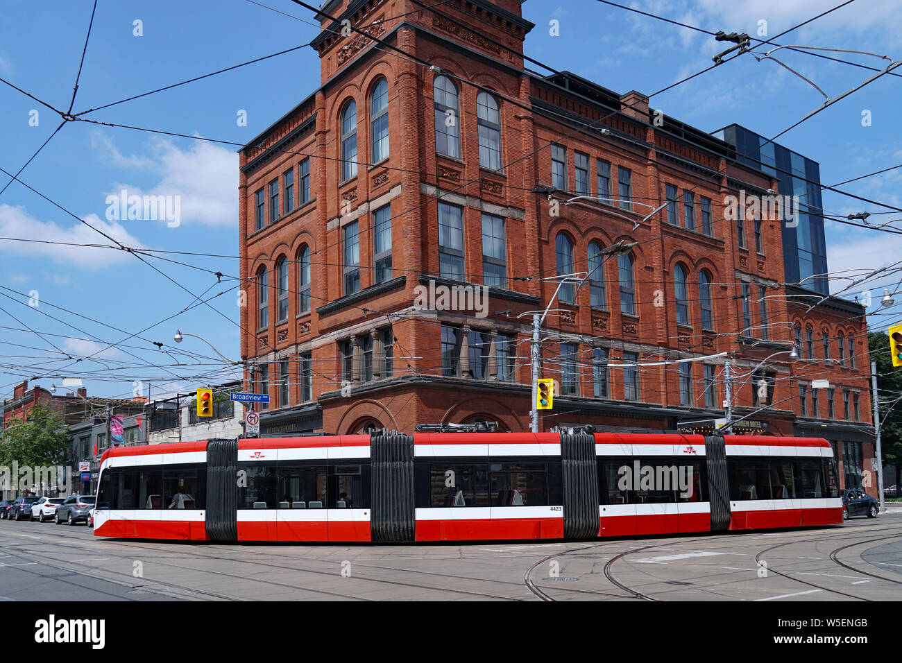 TORONTO - JULY 2019: A modern articulating streetcar bends to turn a ...
