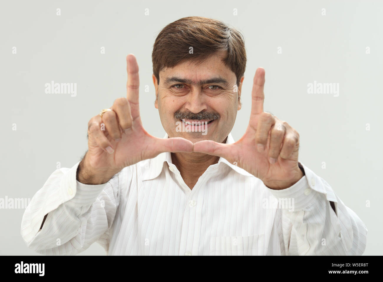 Film director framing a location with his hands Stock Photo - Alamy