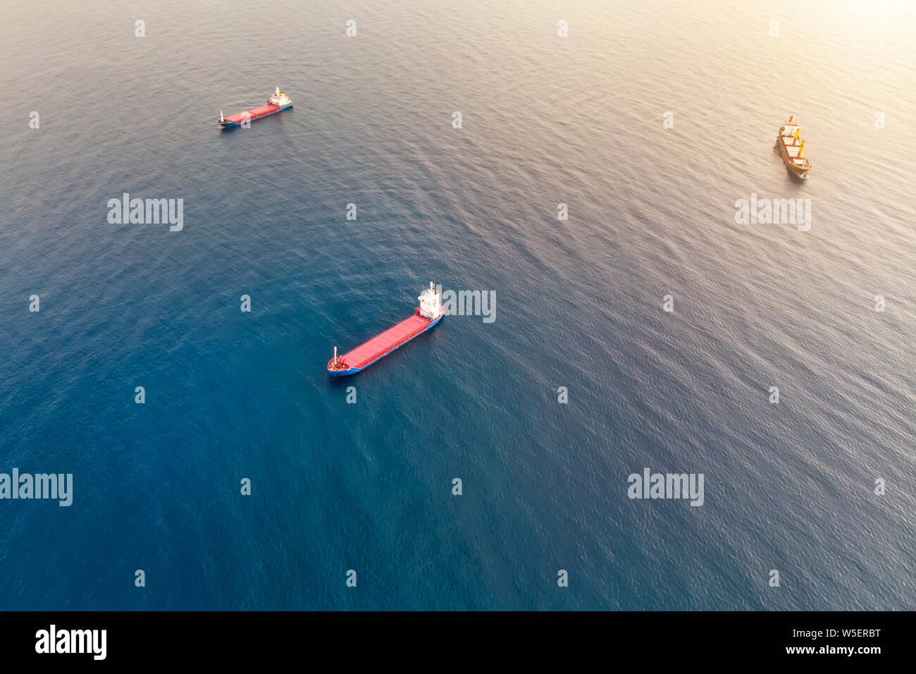 Aerial view of three container ships at sea engaged in transportation ...