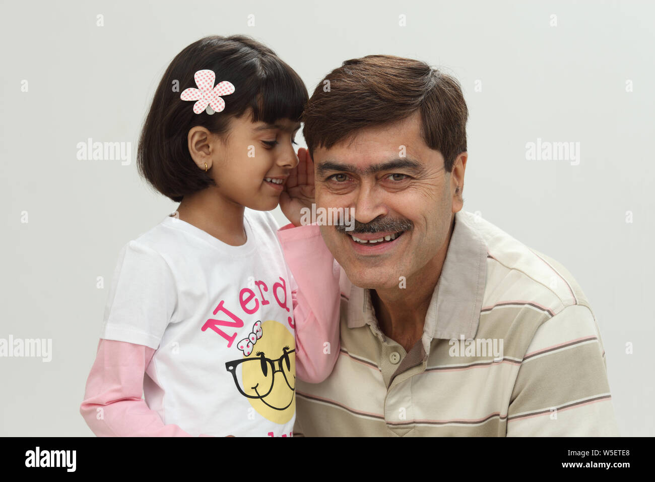Girl whispering into her grandfather,s ear Stock Photo - Alamy