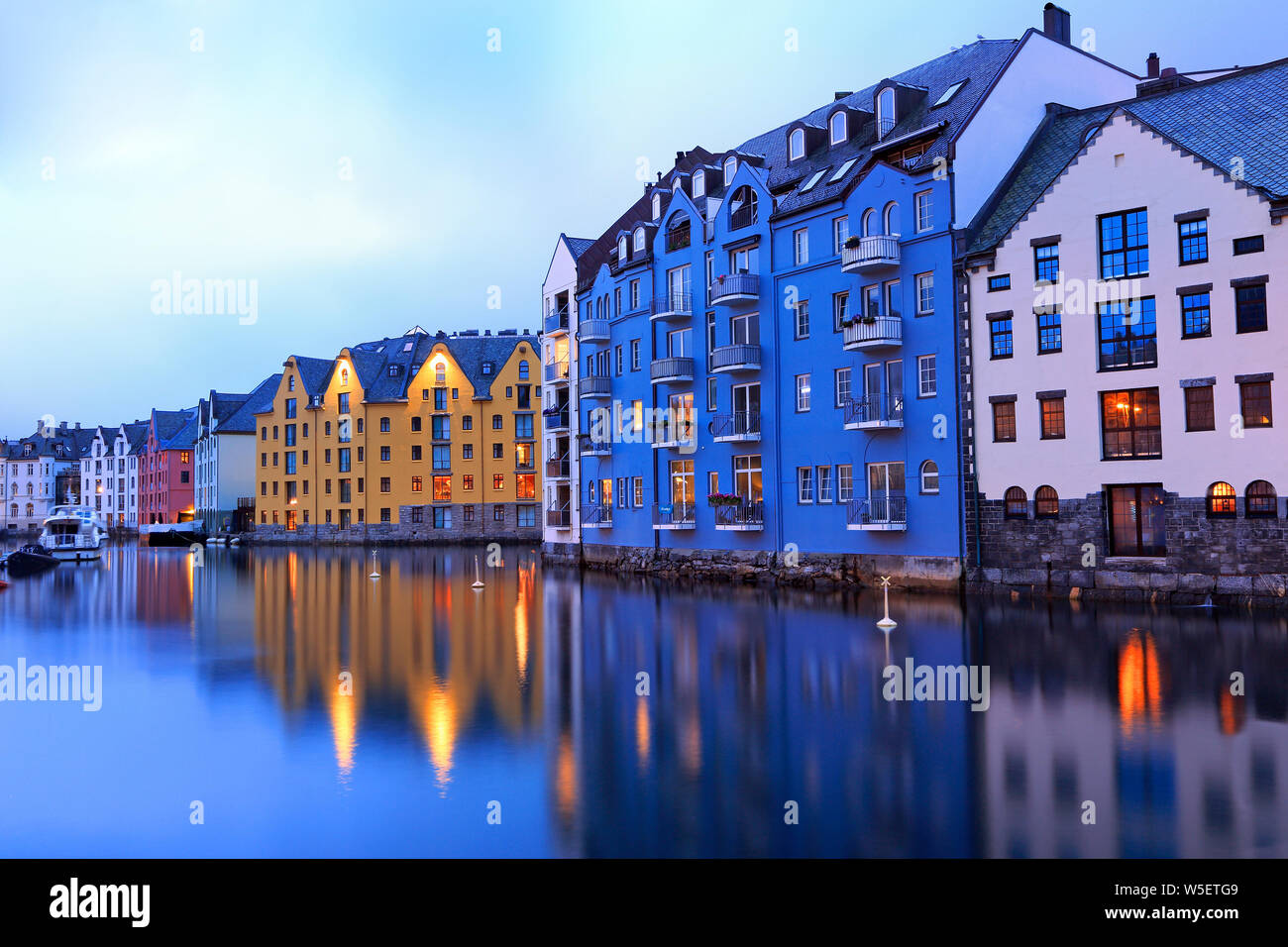 Scenic Alesund skyline architecture at dusk with nice reflection in the ...