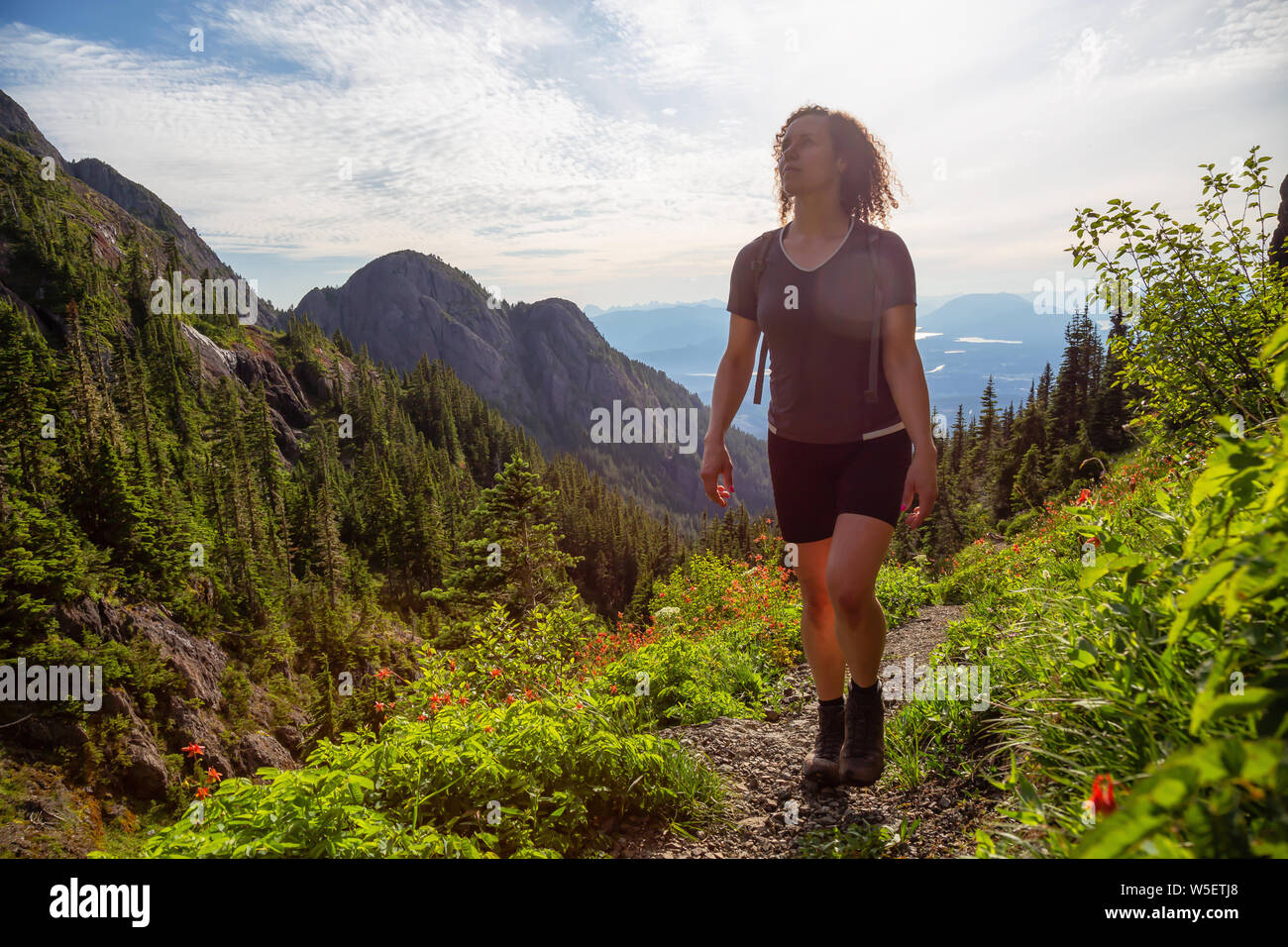 Adventurous girl hiking the beautiful trail in the Canadian Mountain ...