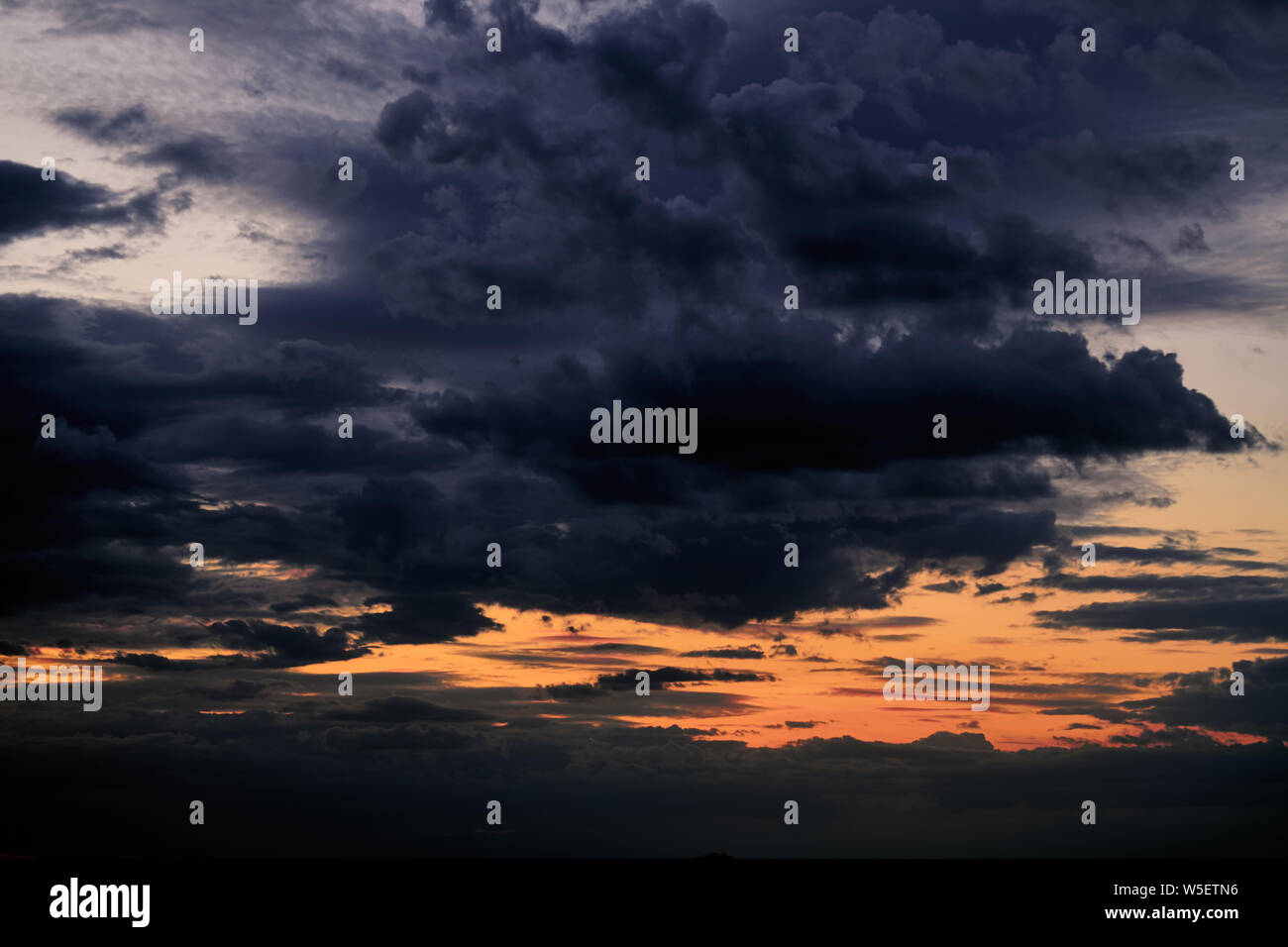 Beautiful sunset - dark sky with clouds and sunlight Stock Photo - Alamy