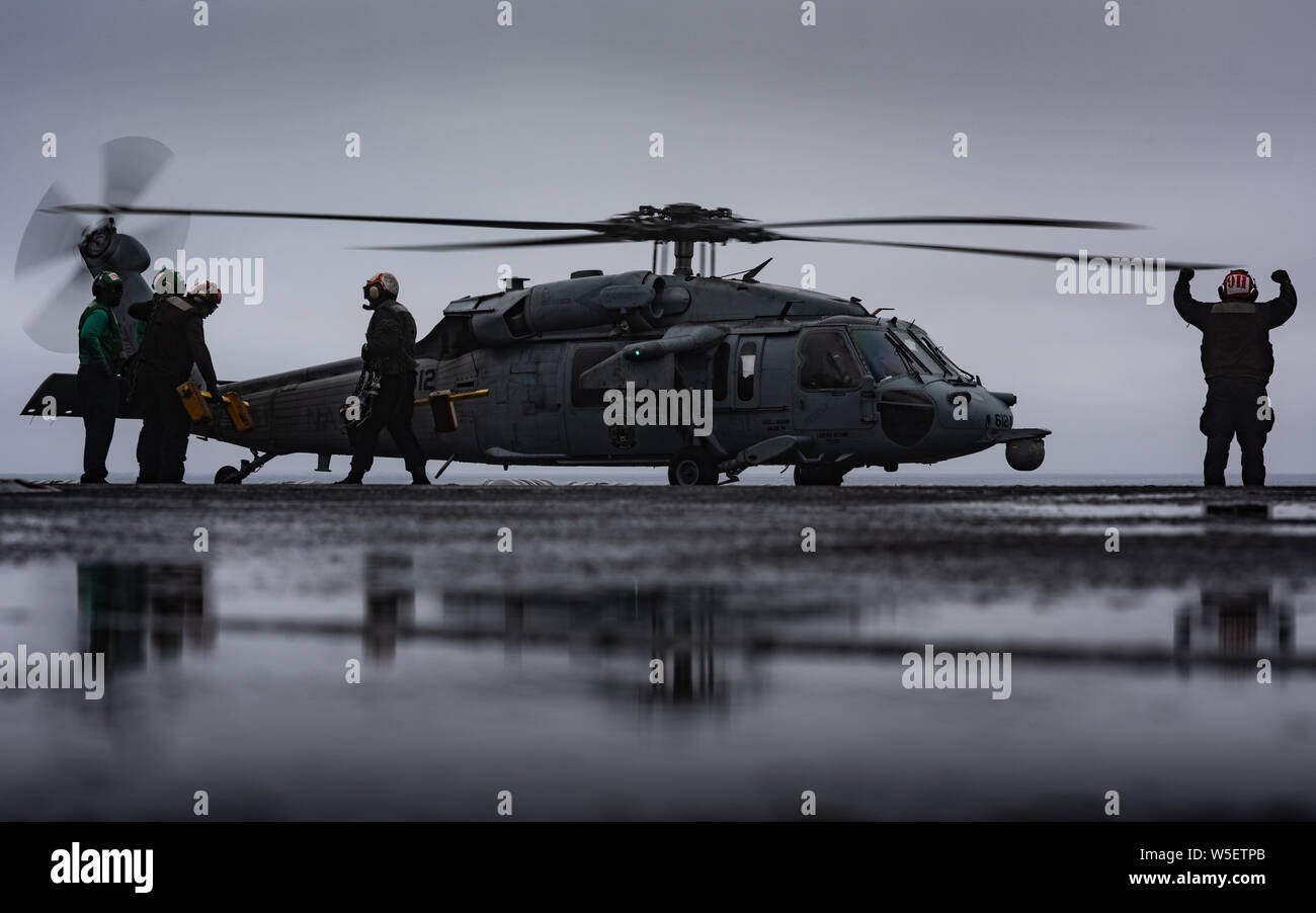 190727-N-ZM949-1029 PACIFIC OCEAN (July 27, 2019) Sailors remove chocks ...