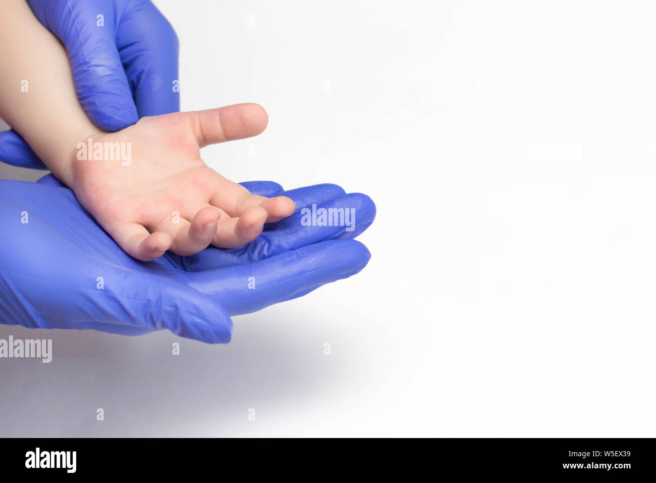 Children's hand in the hands of a pediatrician pediatric doctor concept ...