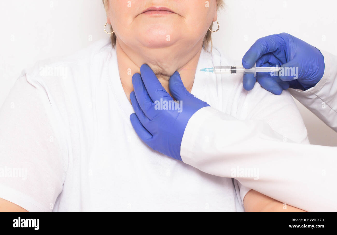 A doctor makes injections of ozone therapy and mesotherapy to a woman ...
