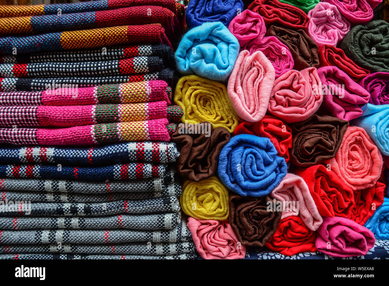 Colorful textile for sale at a street market in Fenghuang Ancient Town ...
