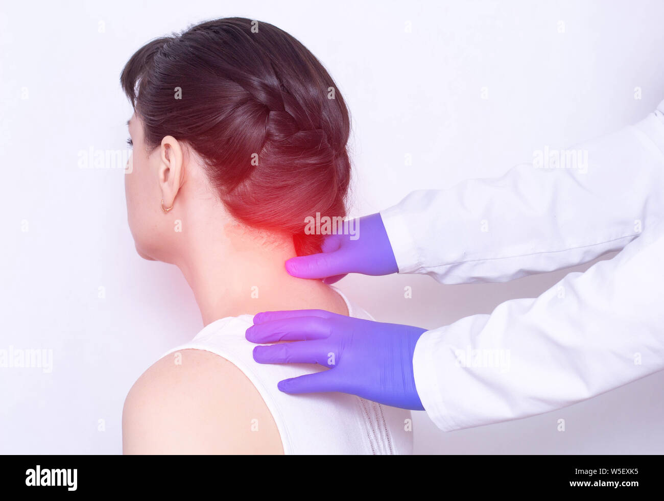 Doctor neurologist examines the patient's sore neck on a pinched nerve ...
