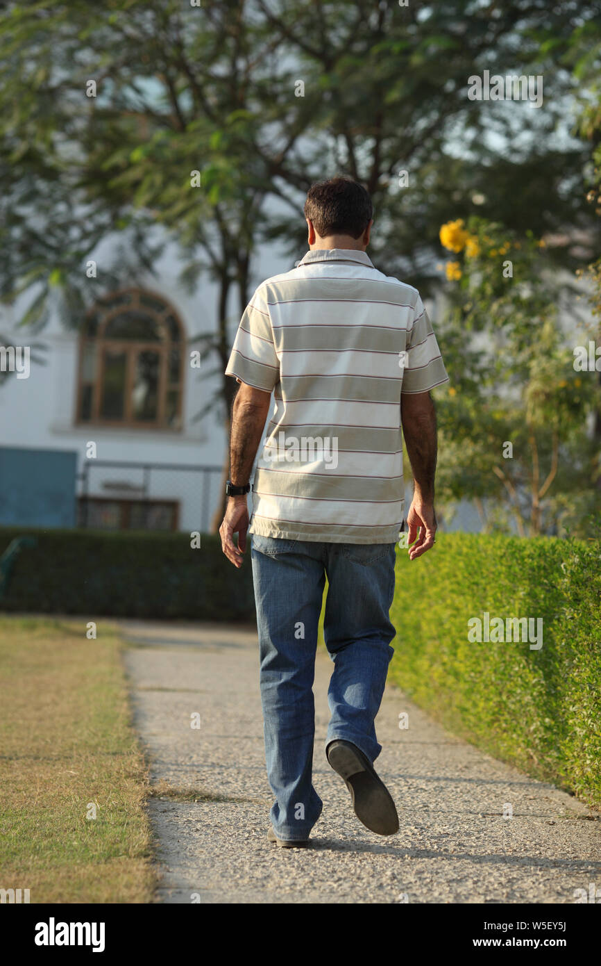 Rear view of an Indian man walking in a park Stock Photo - Alamy