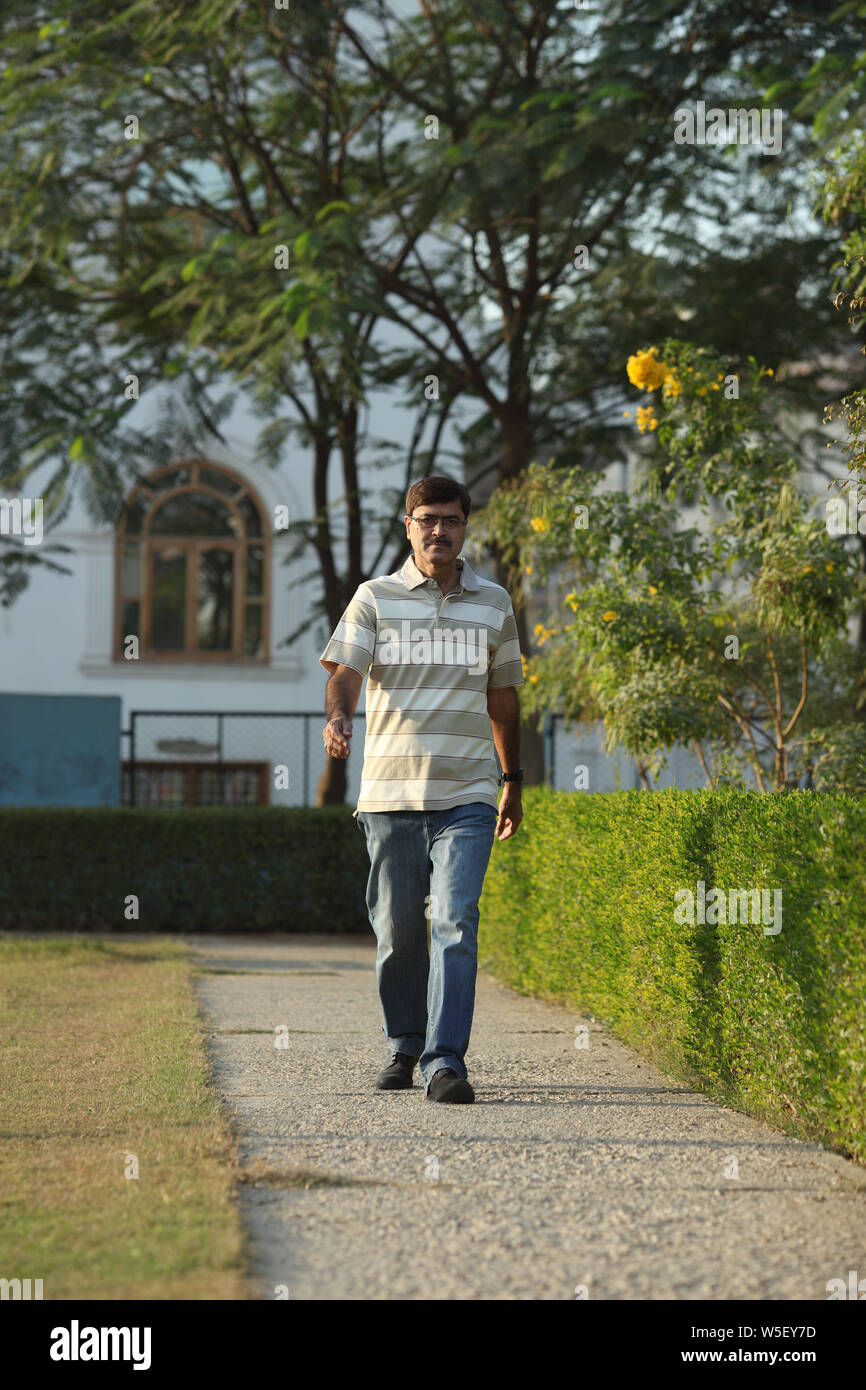 Man walking in a park Stock Photo - Alamy