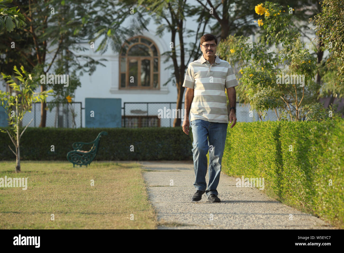 Man walking in a park Stock Photo - Alamy