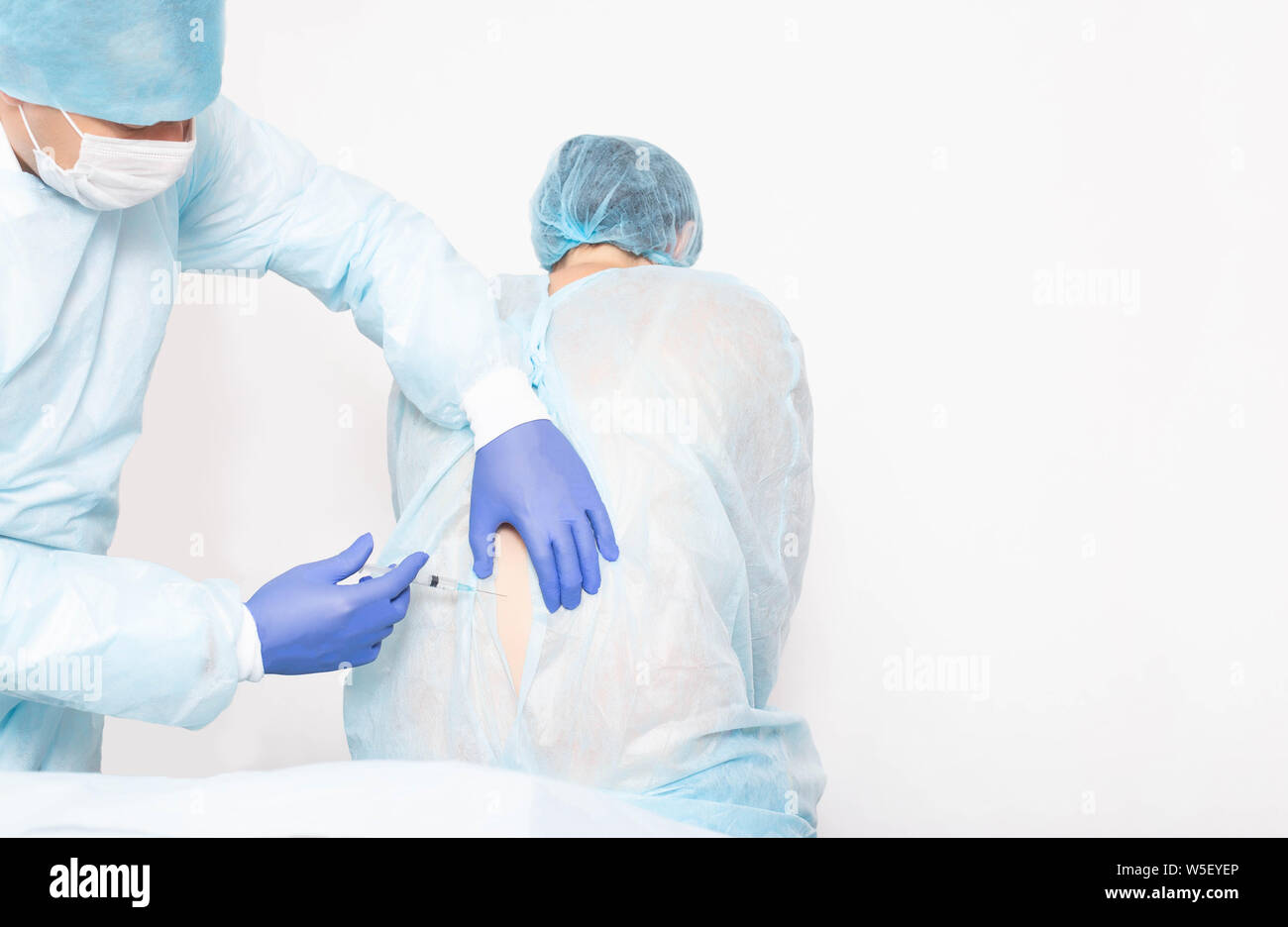 A male anesthesiologist performs a surgical procedure that introduces ...
