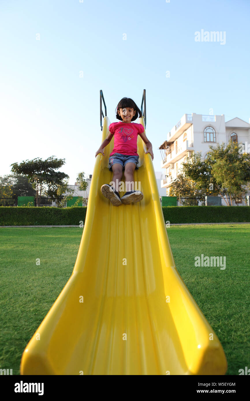 Girl on a slide Stock Photo - Alamy