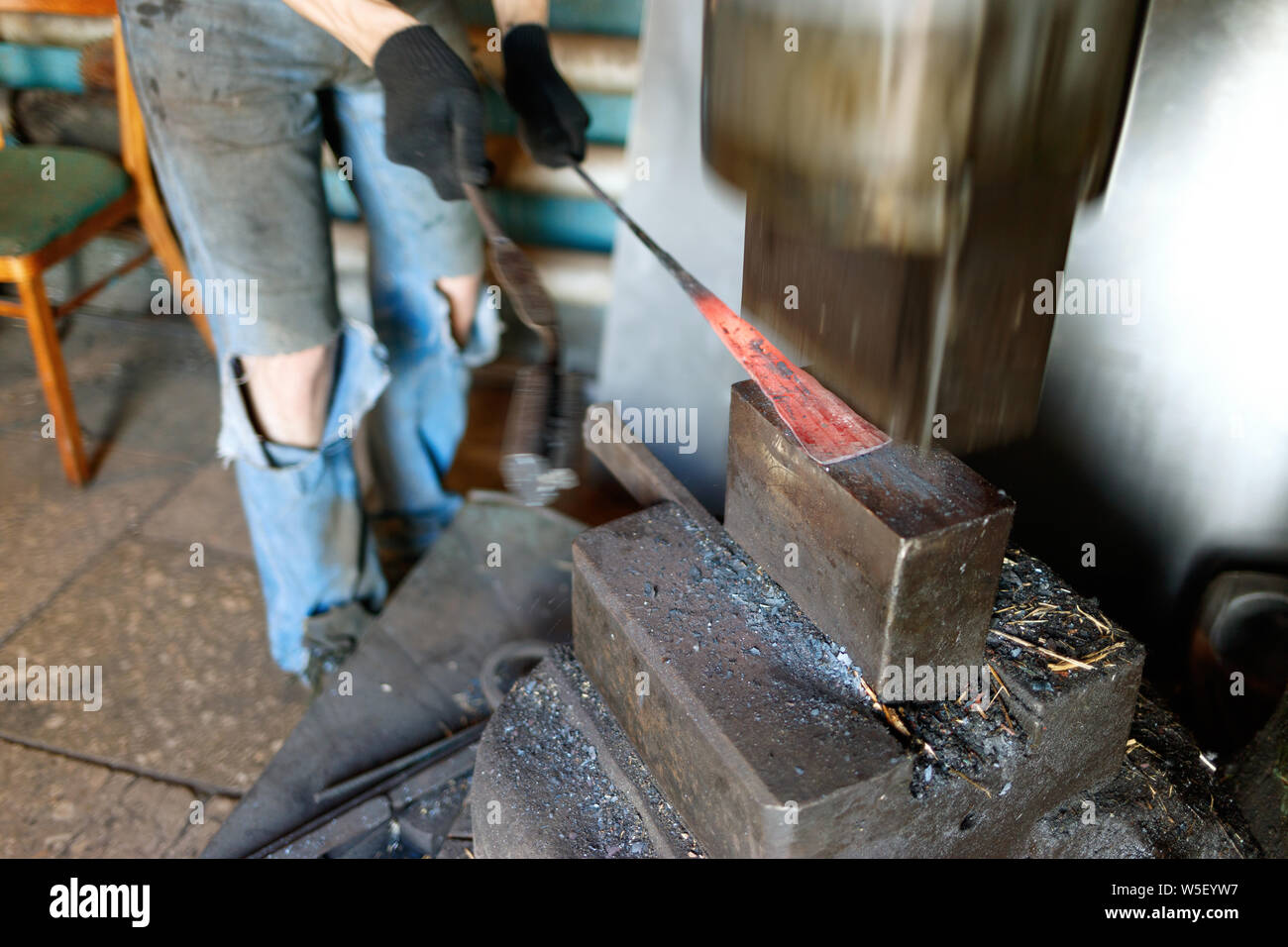 Blacksmith forging by using pneumatic hammer Stock Photo - Alamy