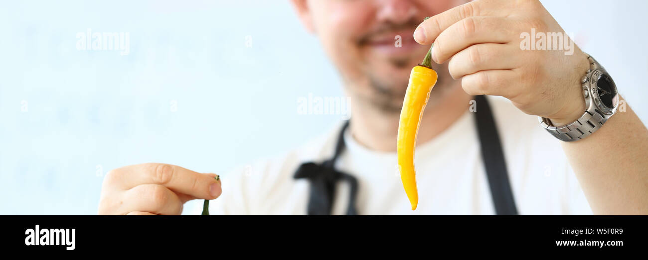 Smiling man holding chili pepper hi-res stock photography and images ...