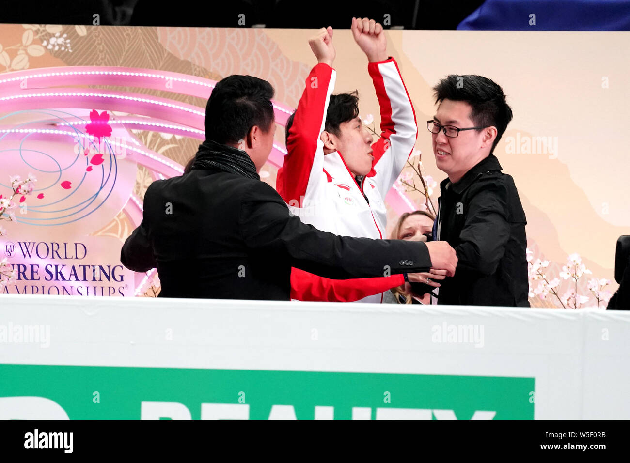 Chinese figure skaters Sui Wenjing and Han Cong, center, celebrate with ...