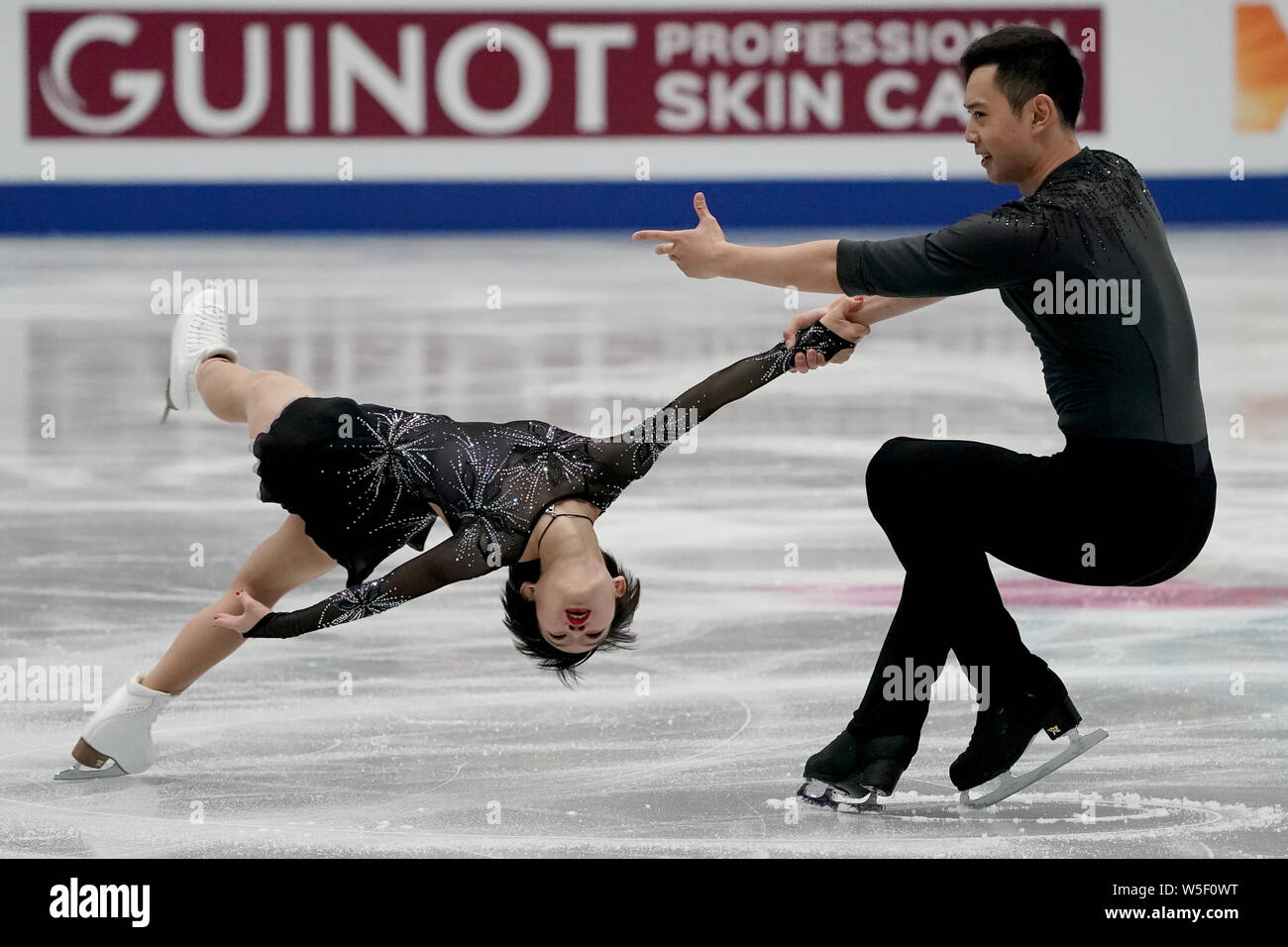 Chinese figure skaters Peng Cheng and Jin Yang compete in the Pairs ...