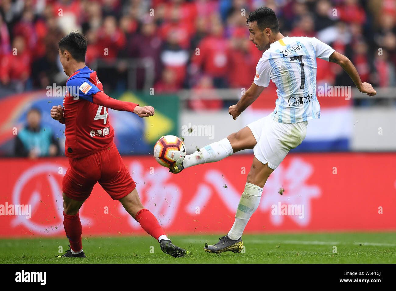 Israeli football player Eran Zahavi, right, of Guangzhou R&F passes the ...