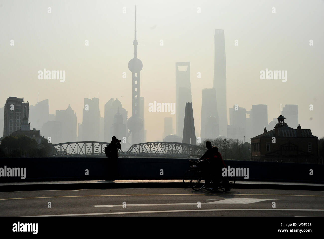 Local residents walk on the Waibaidu Bridge against skyline of the ...