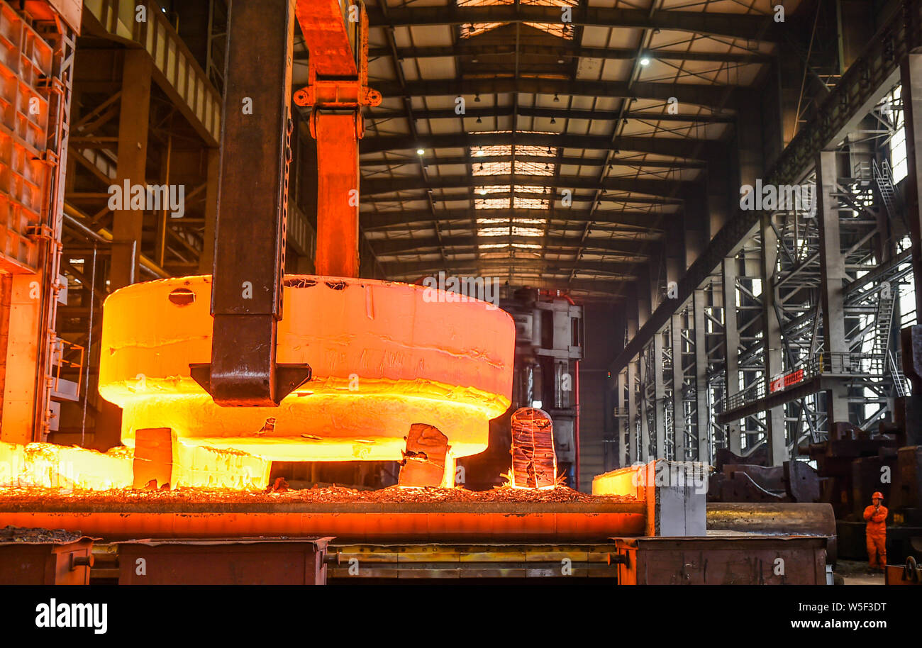 --FILE--Chinese workers check a seamless forging piece at a forging ...