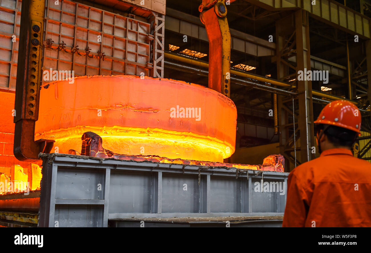 --FILE--Chinese workers check a seamless forging piece at a forging ...