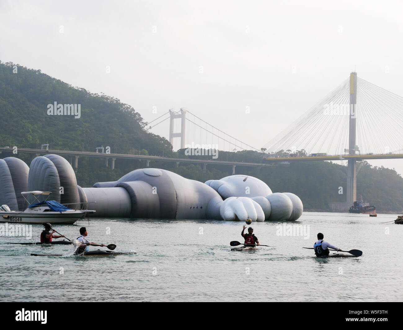 The 37-metre-long floating sculpture by US artist Kaws is placed at the ...
