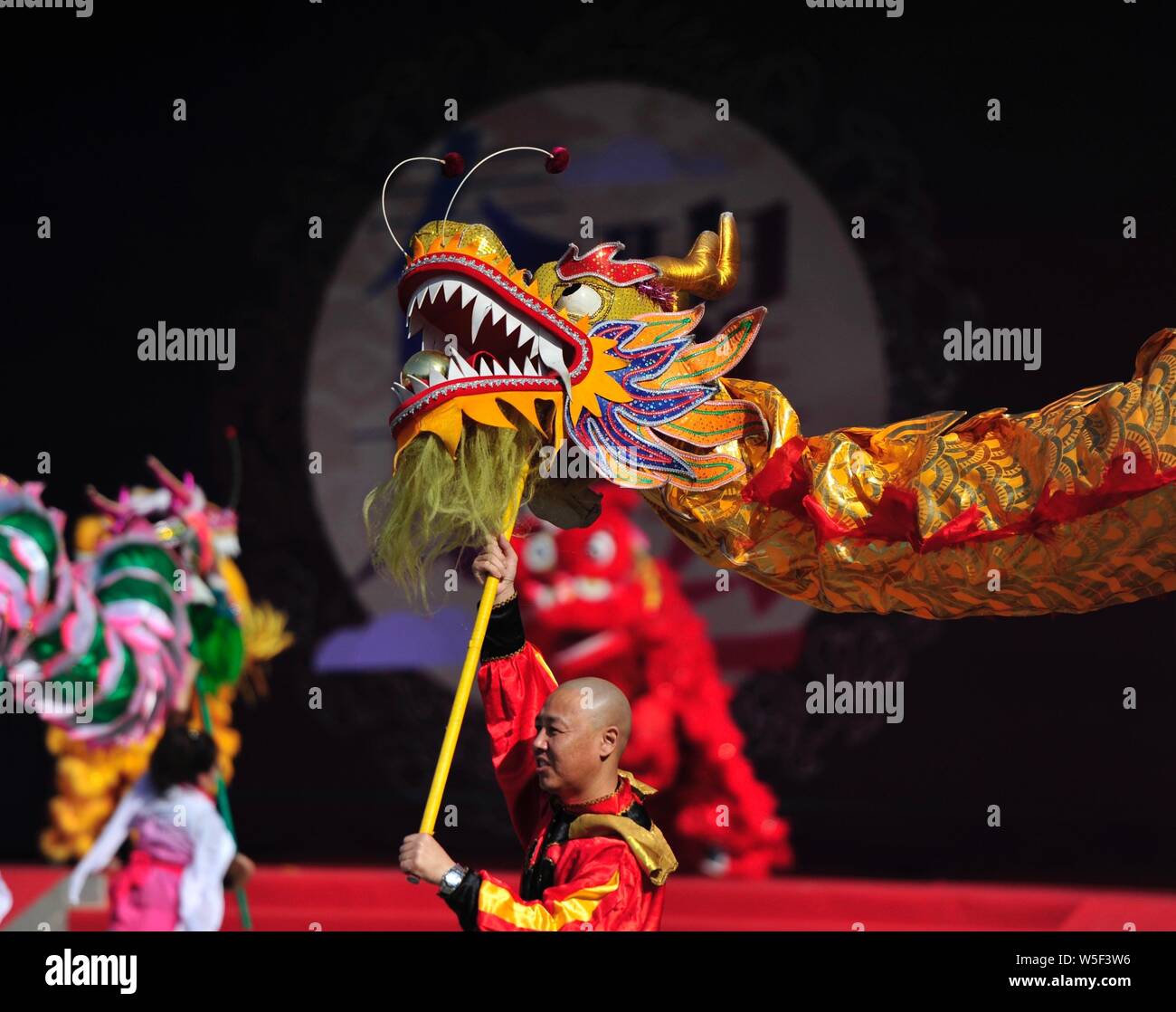 Chinese entertainers perform a dragon dance to celebrate the Dragon ...