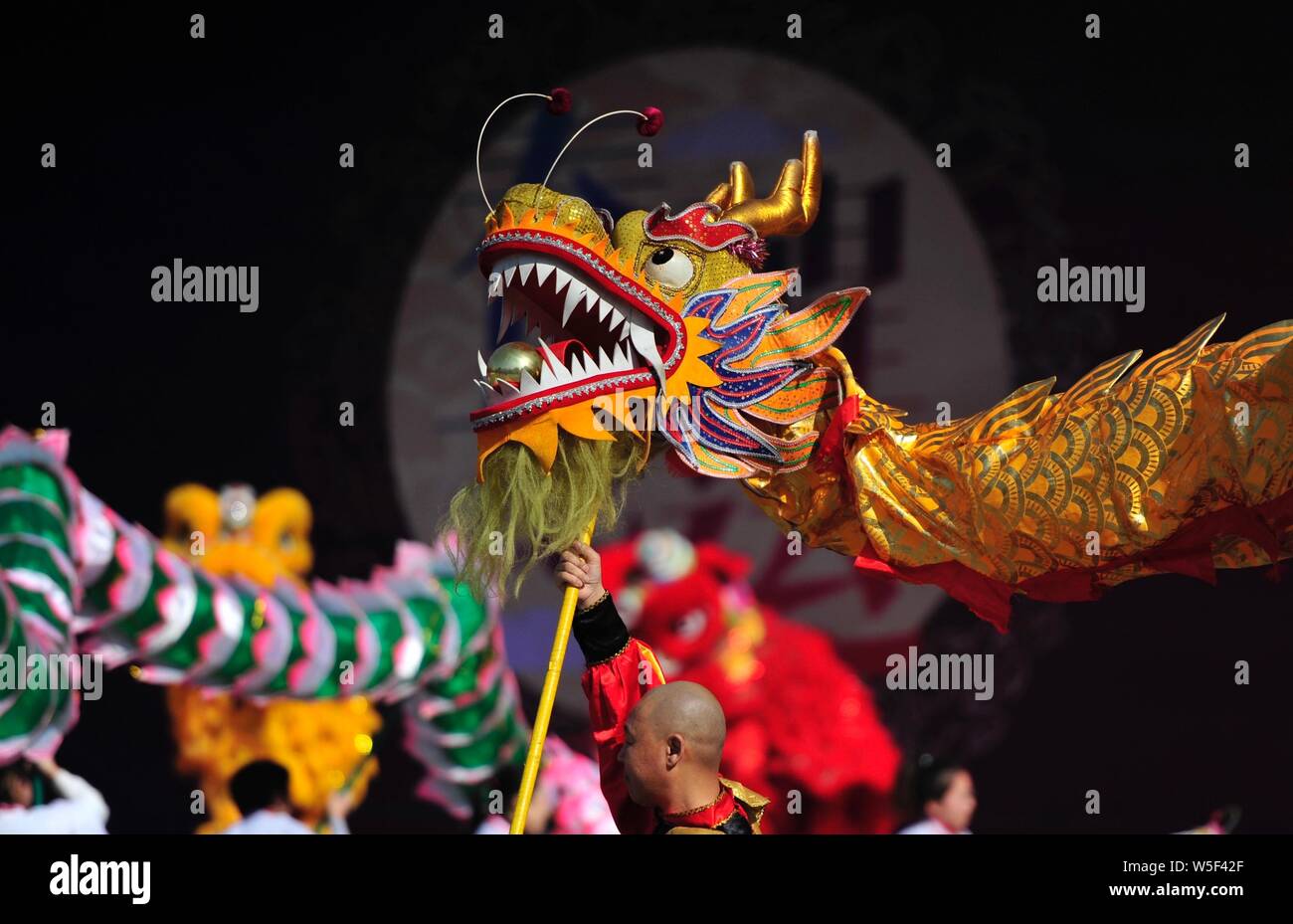 Chinese entertainers perform a dragon dance to celebrate the Dragon ...