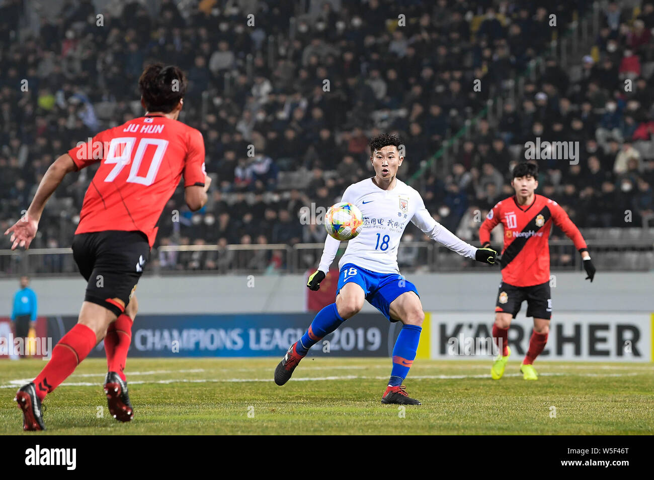 Zhou Haibin of China's Shandong Luneng FC dribbles against South Korea ...