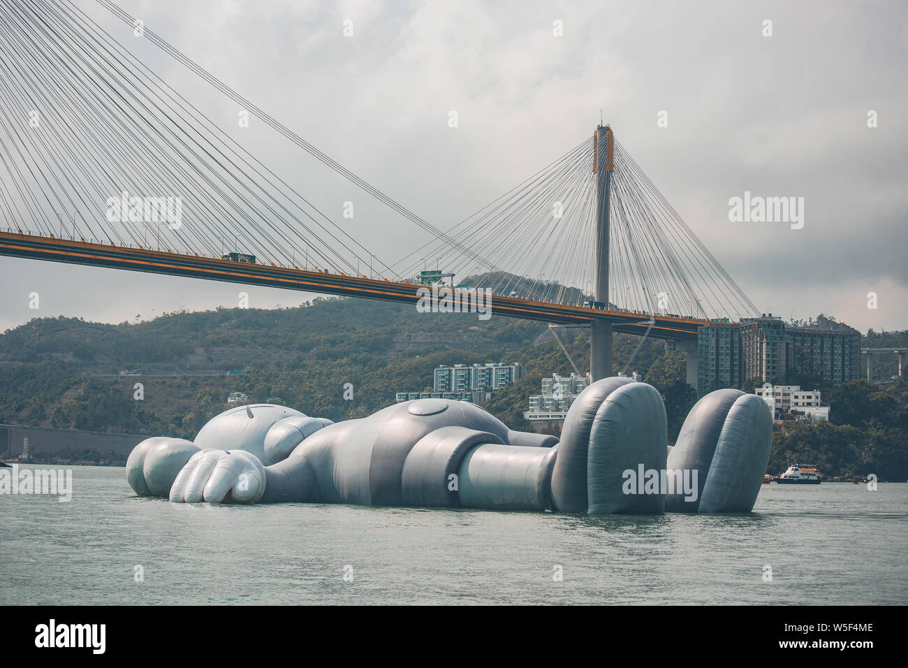 The 37-metre-long floating sculpture by US artist Kaws is placed at the ...