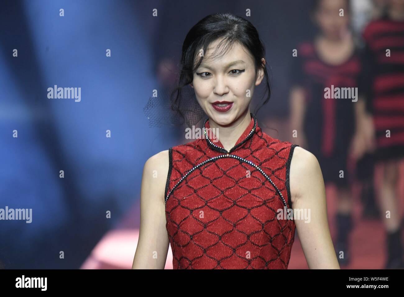 A blind model, top, displays a new creation at the fashion show of ...