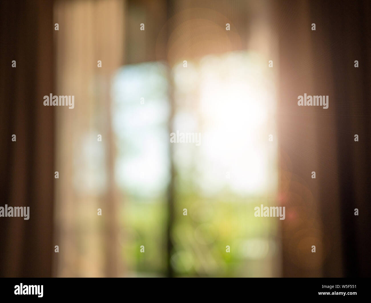 Blurred window with curtains and sunlight Stock Photo - Alamy