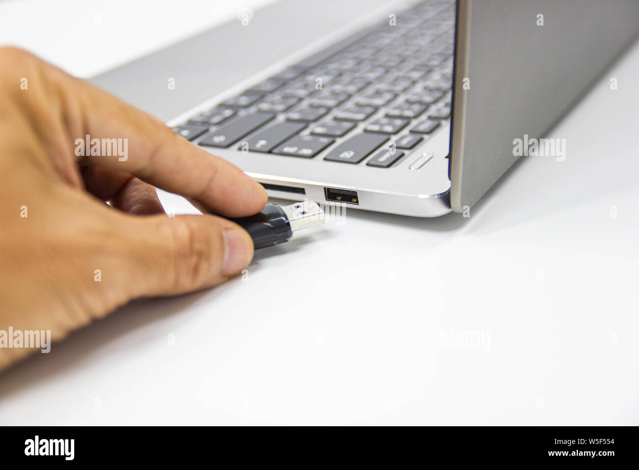 hand man hold Flash drive connect to USB port plug-in computer laptop ...