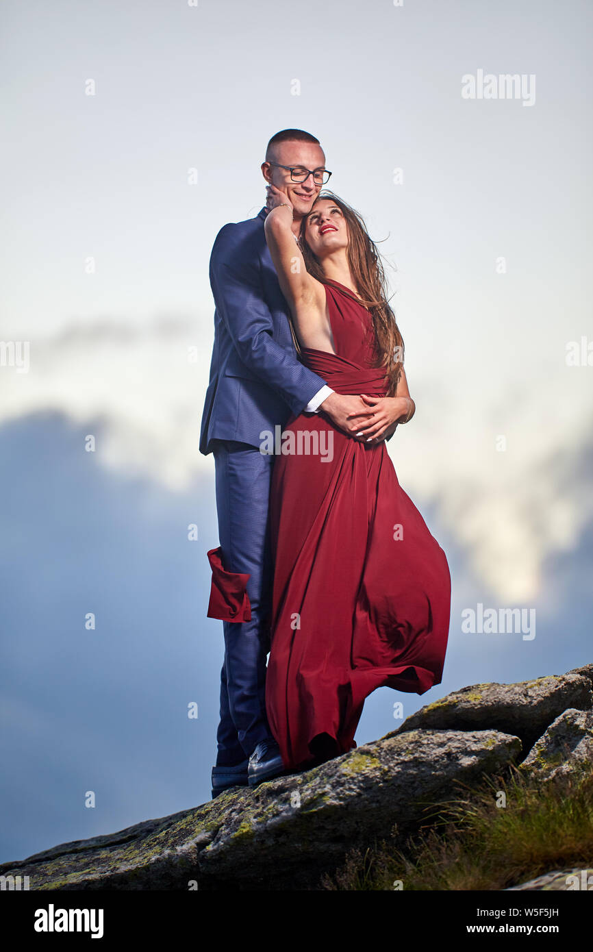 Romantic young couple on top of the mountain Stock Photo - Alamy