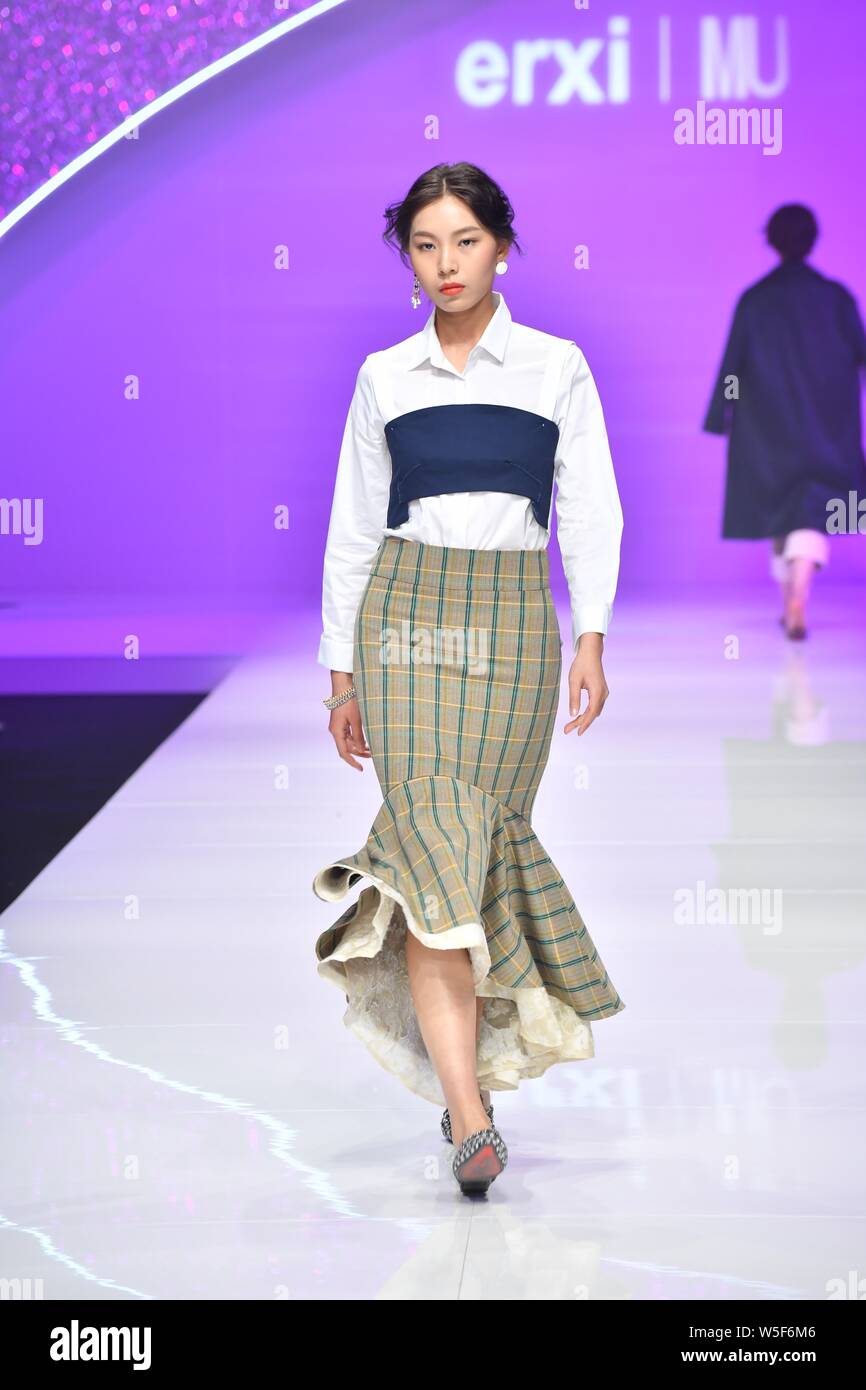 A model displays a new creation at the fashion show of City Fashion ...