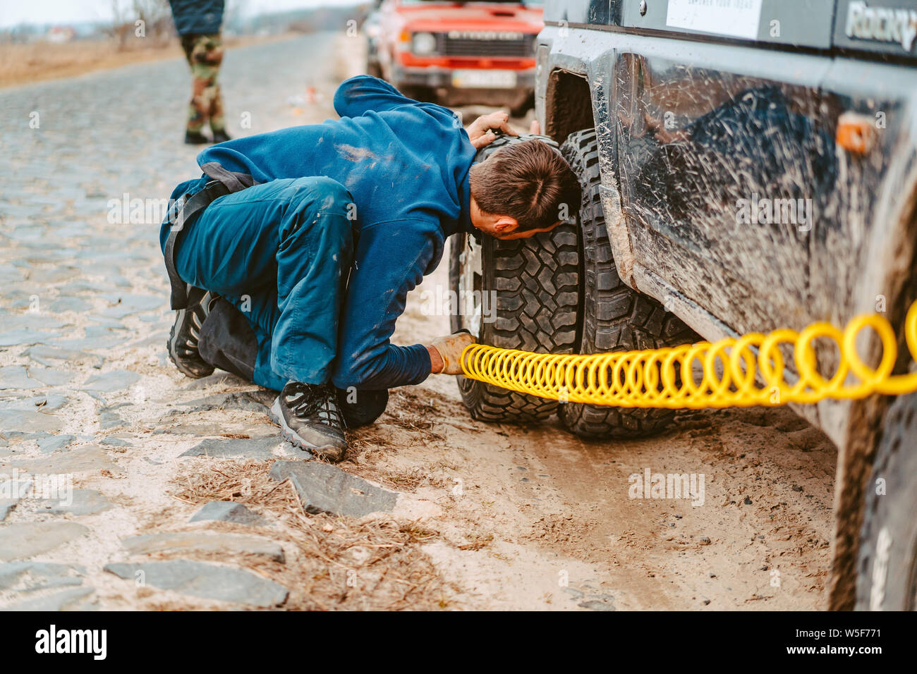 A man pumps air wheel with a compressor Stock Photo - Alamy