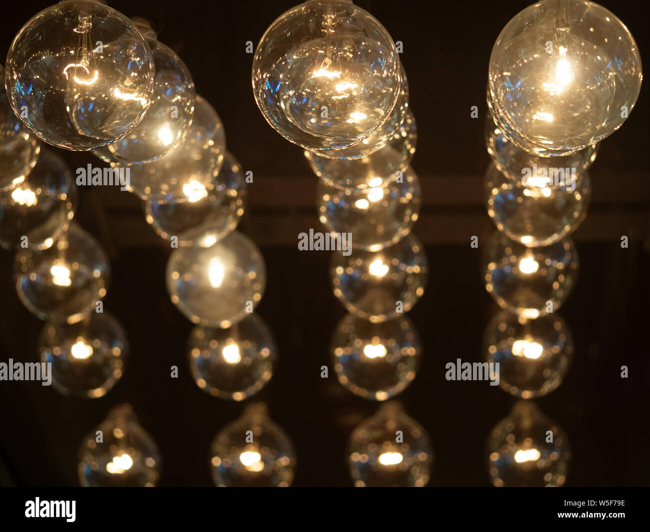 Many light bulbs on the black scene. Lighting decor, vintage lamp, bulb ...