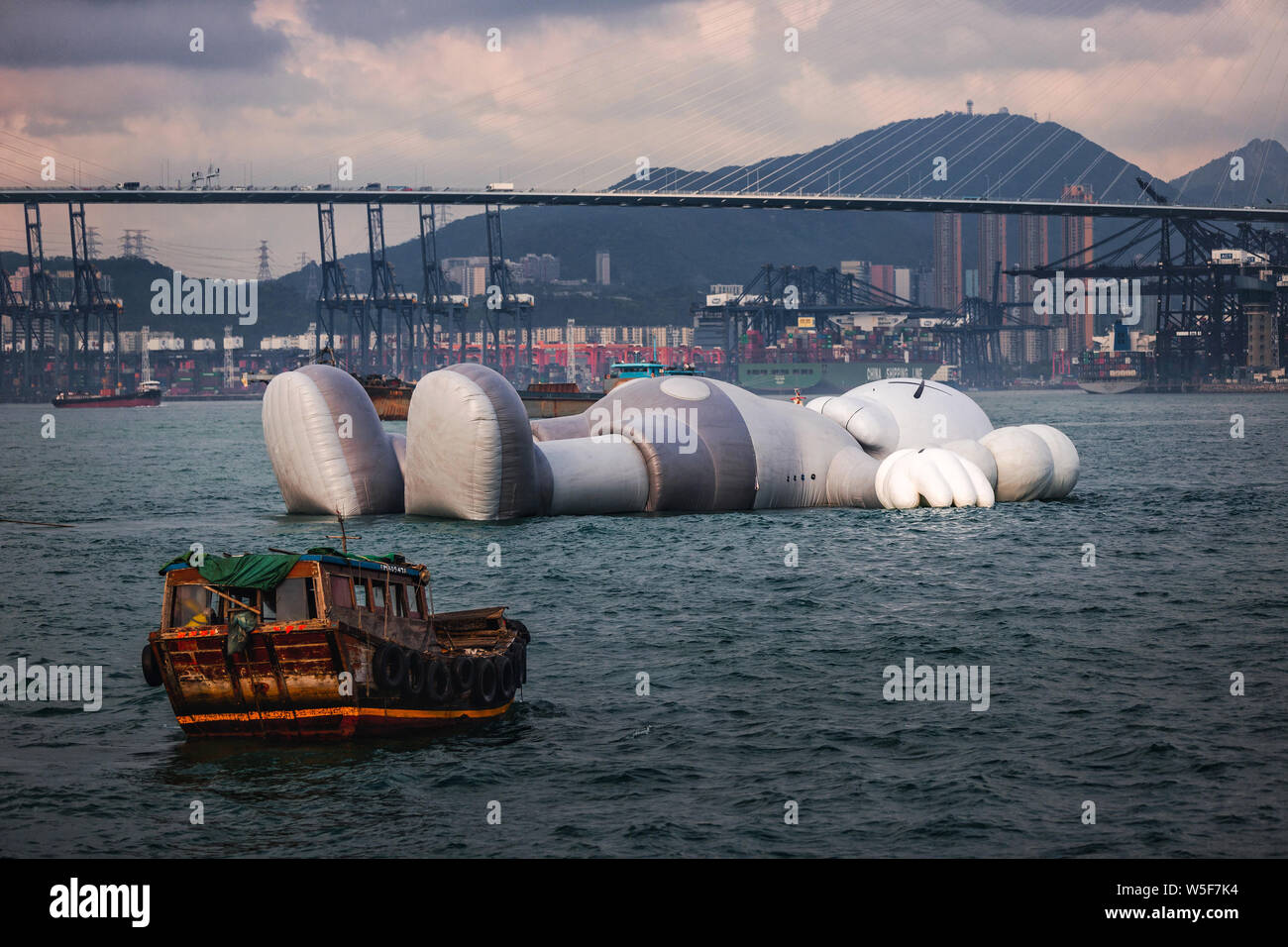 The 37-metre-long floating sculpture by US artist Kaws is placed at the ...