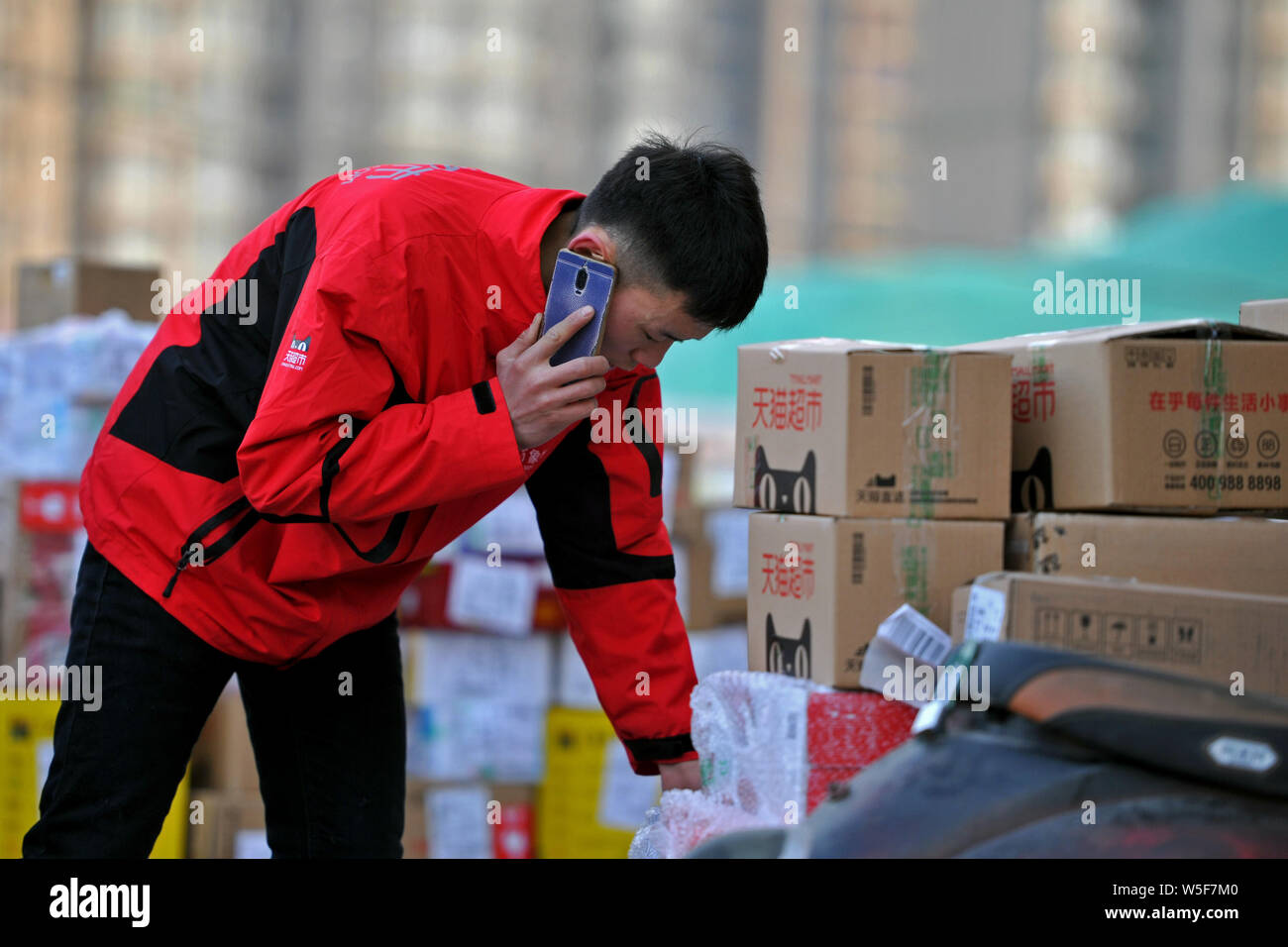 A Chinese courier of an express delivery company sorts out parcels from ...