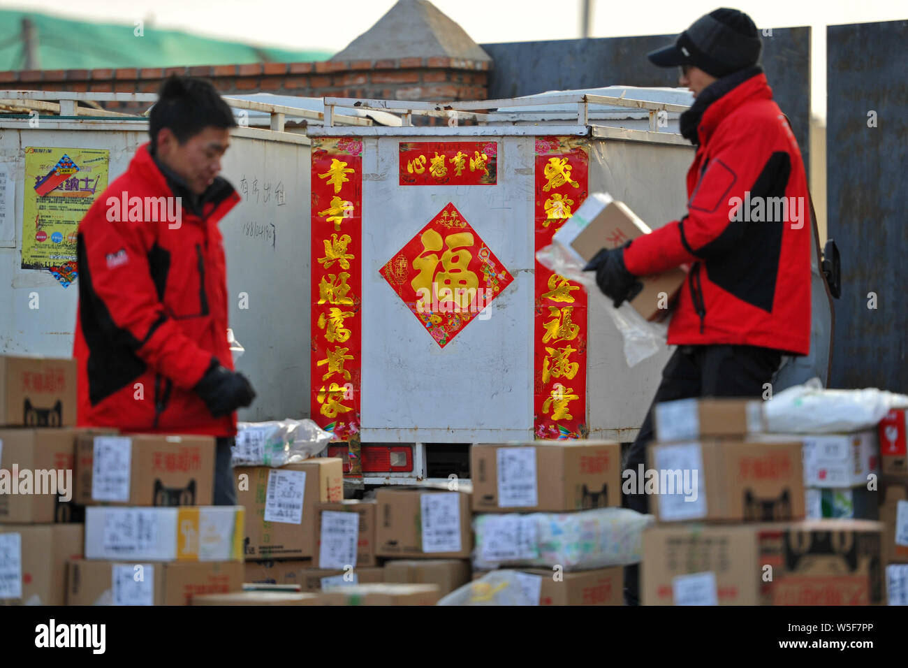 Chinese couriers of an express delivery company sort out parcels from ...
