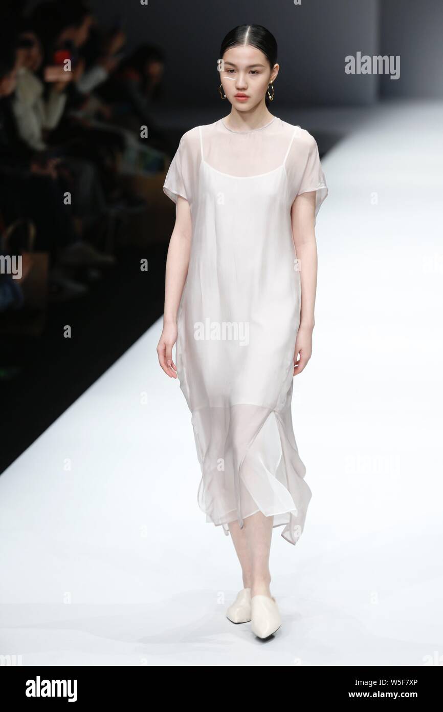 A model displays a new creation at the fashion show of City Fashion ...