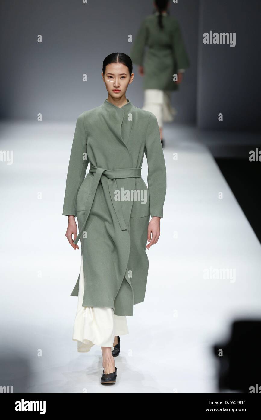 A model displays a new creation at the fashion show of City Fashion ...