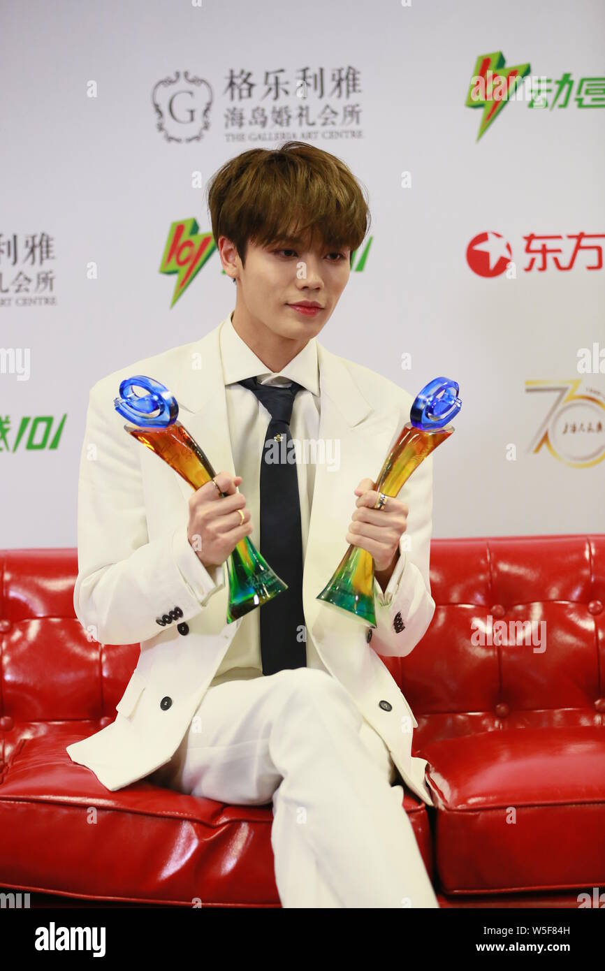 Lin Yanjun of Chinese boy group Nine Percent poses with his trophys ...