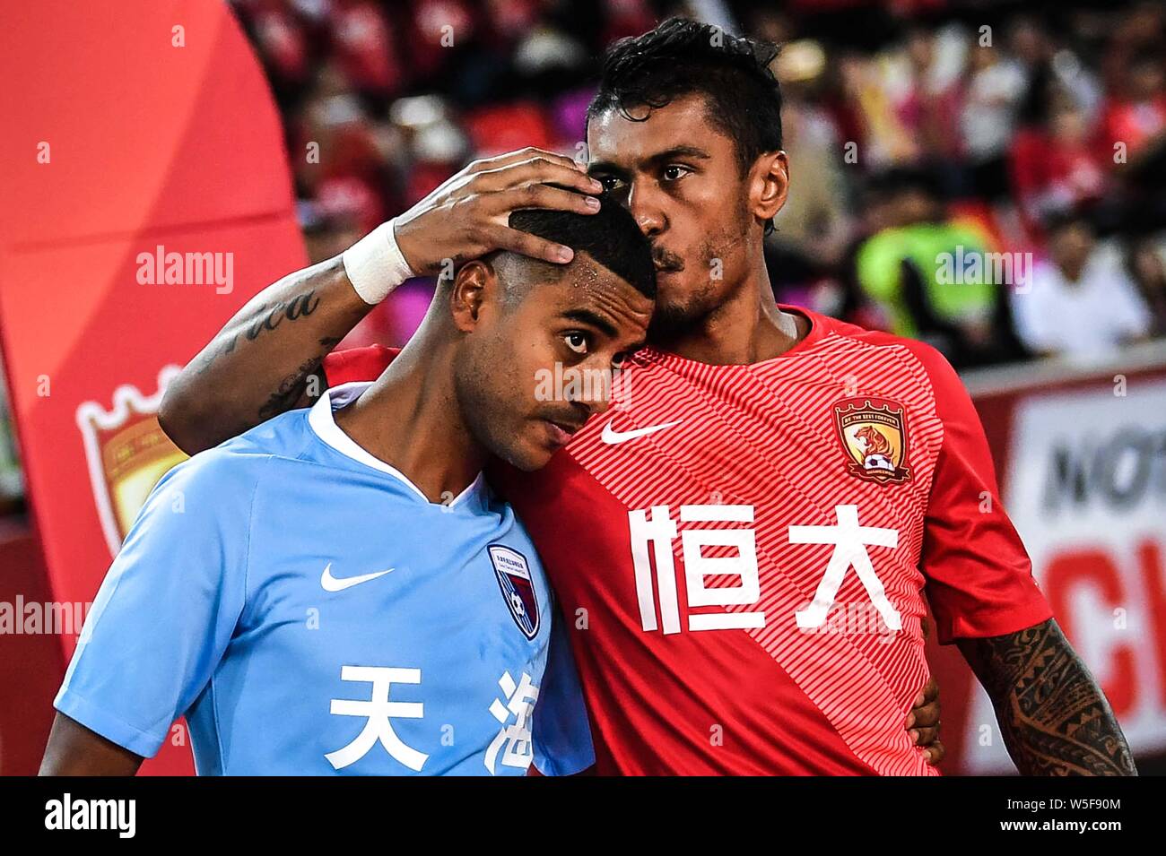 Brazilian soccer player Paulinho, right, of Guangzhou Evergrande Taobao ...