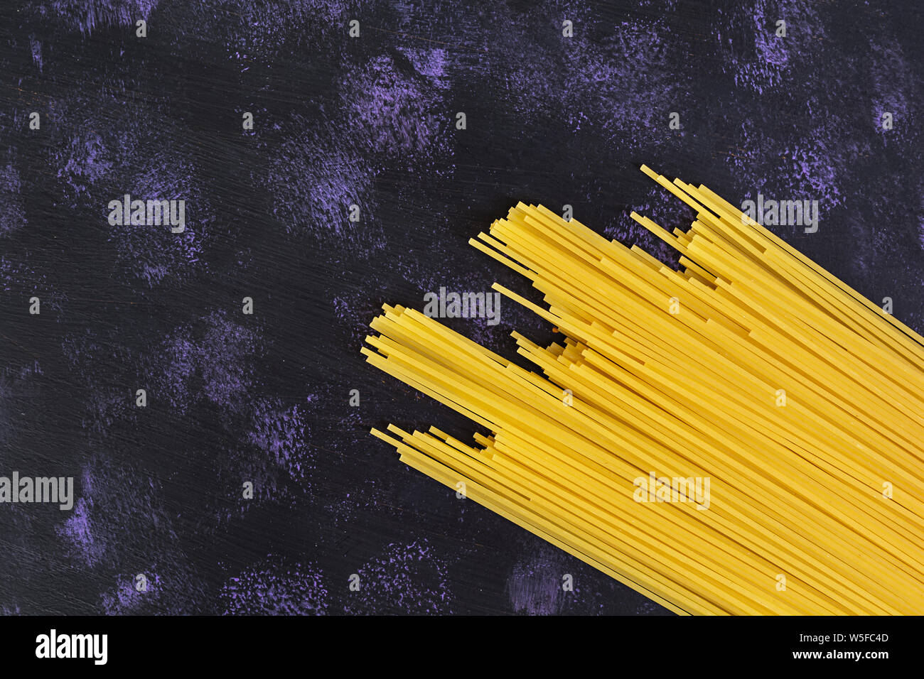 Dry pasta background. Spaghetti pasta on dark background. Flat lay. Top ...