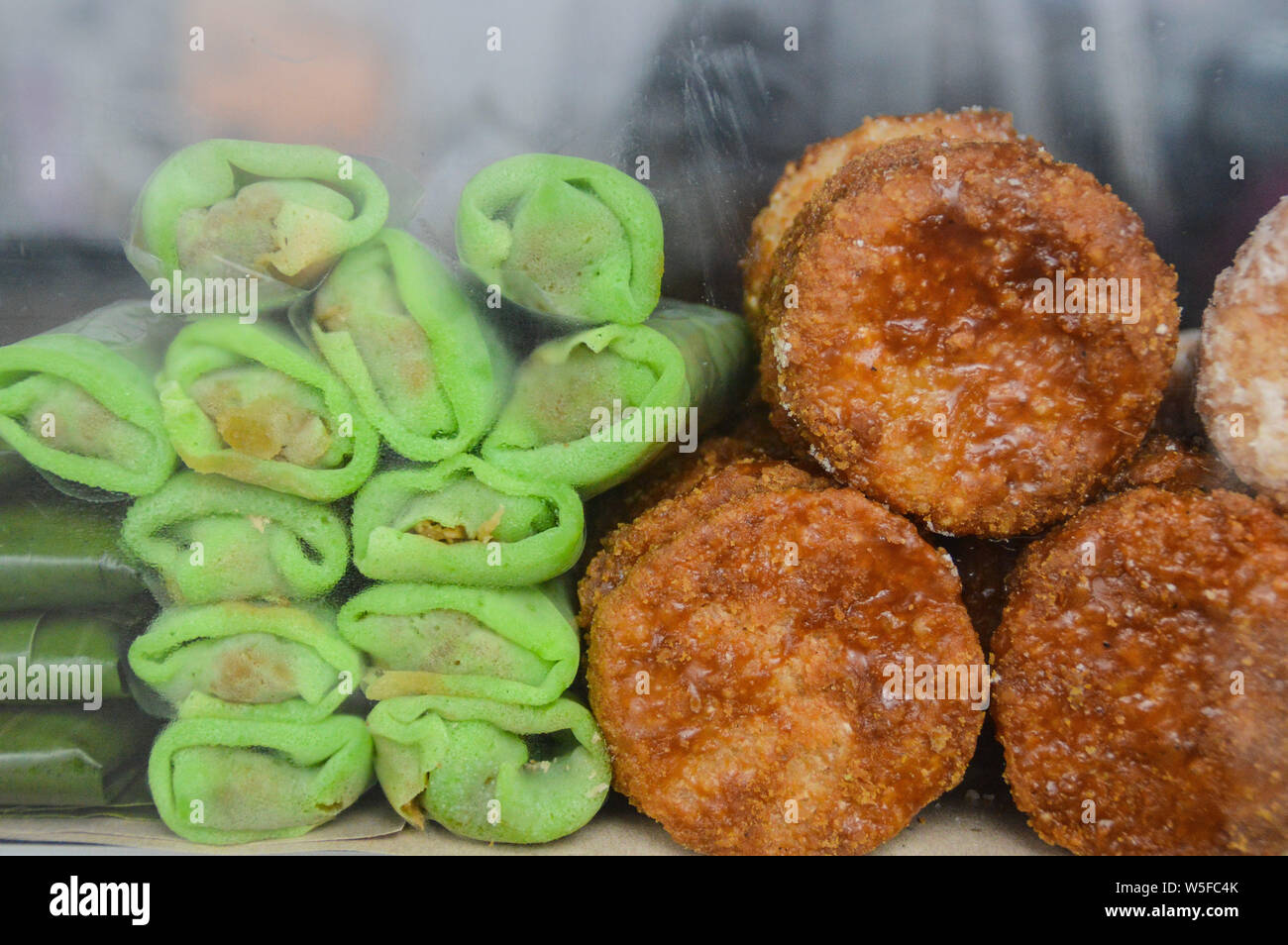 Traditional Indonesian snacks sold in small street stalls across Medan ...