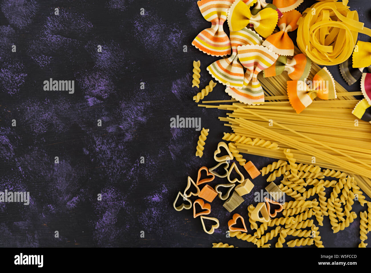 Dry pasta background. Different pasta on dark background. Flat lay. Top ...