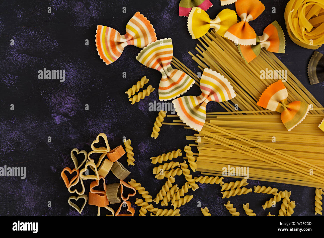 Dry pasta background. Different pasta on dark background. Flat lay. Top ...