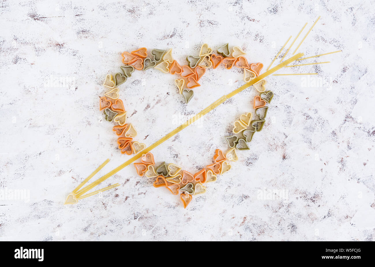 Colorful dry love pasta on white background. Top view Stock Photo - Alamy