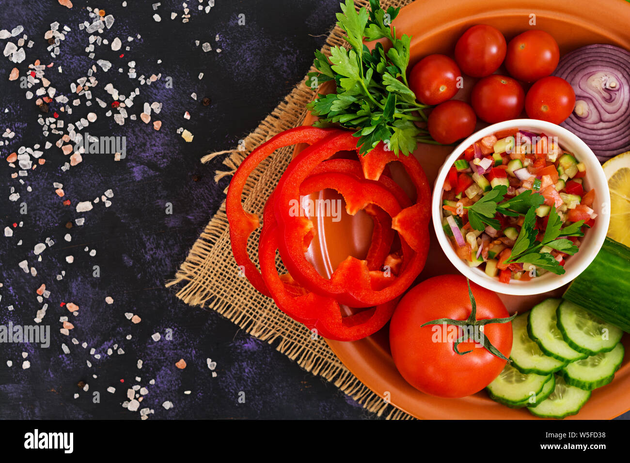 Salsa with ingredients on dark background. Top view Stock Photo - Alamy